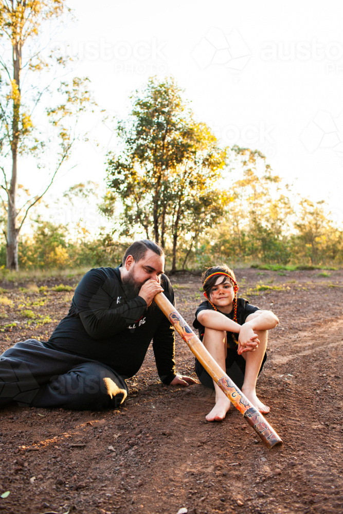 Image of First Nations Australian father teaching Aboriginal son to ...