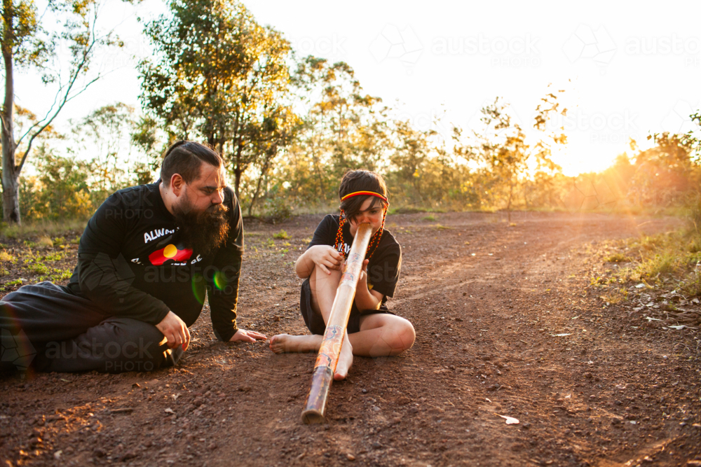 Image of First Nations Australian father teaching Aboriginal son to ...