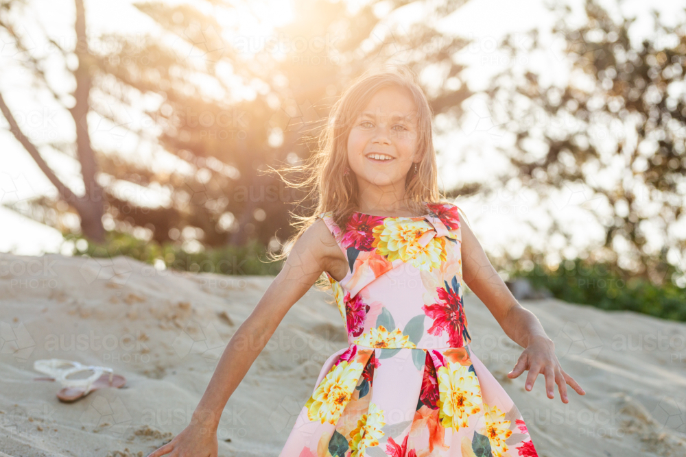 Image of First Nations Australian girl in sunshine playing on a sand ...