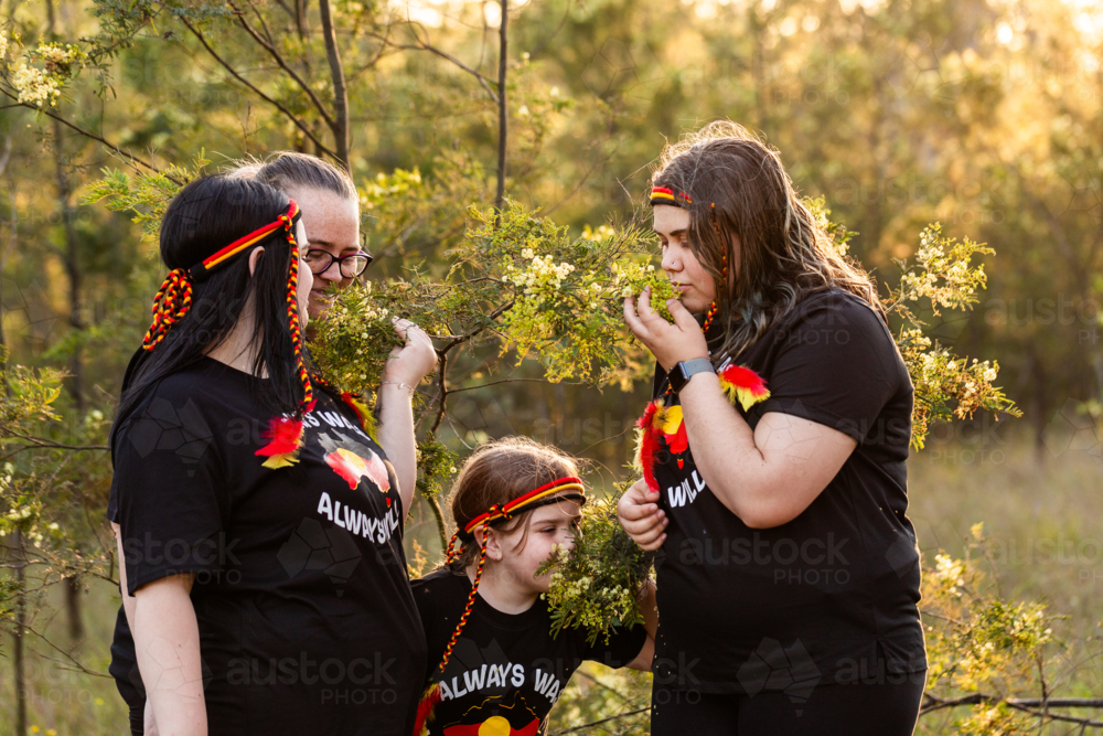 Image of First Nations Australian mother and daughters looking at ...