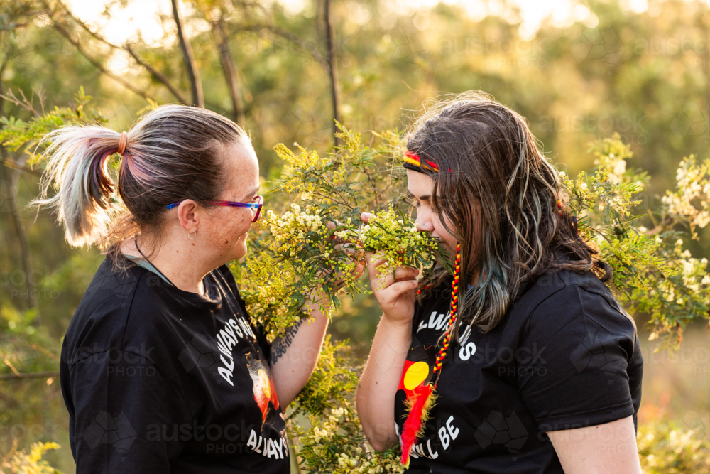 Image of First Nations Australian mother and teen daughter smelling ...