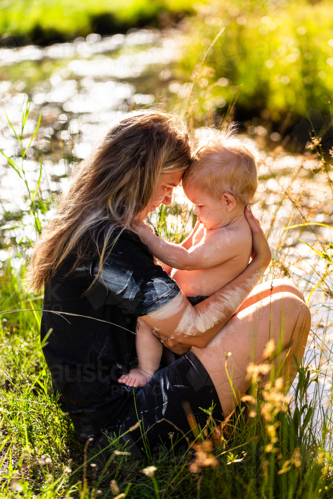 Image of First nations Australian mother holding son together on ...