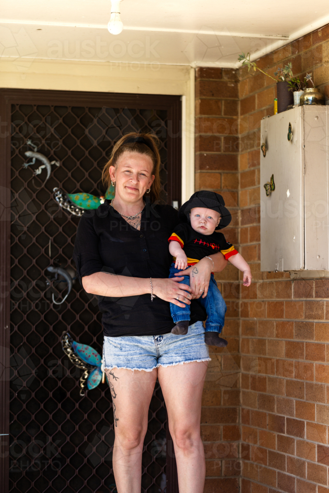 Image of First Nations Australian mum standing by front door of home ...