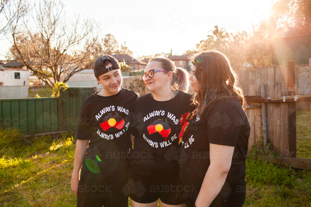 Image of First Nations Australian mum standing with teenaged children ...