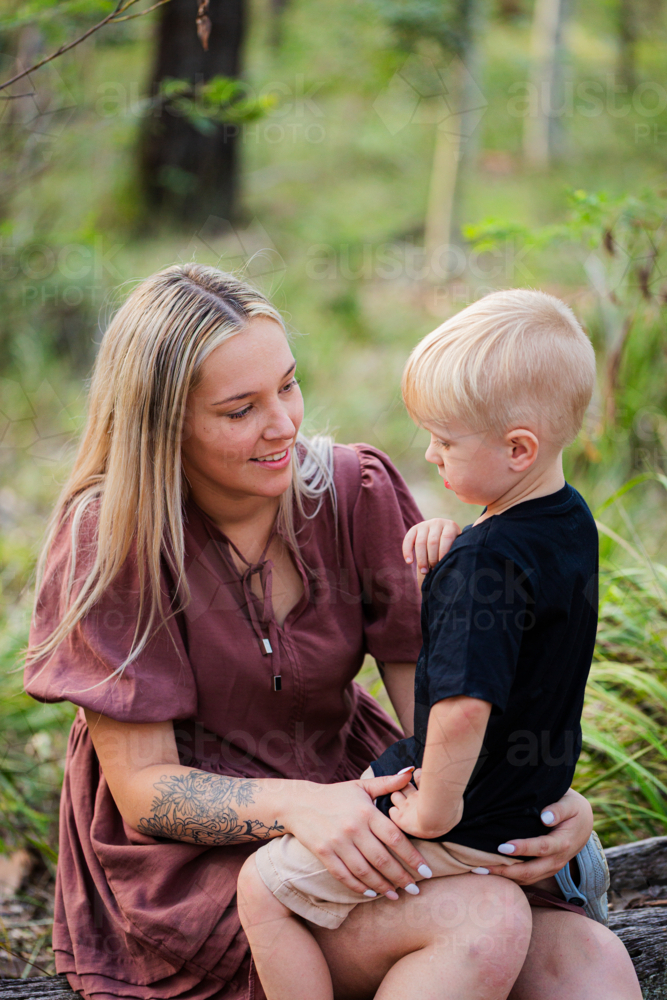 Image of First Nations Australian mum with son sitting on lap in native ...