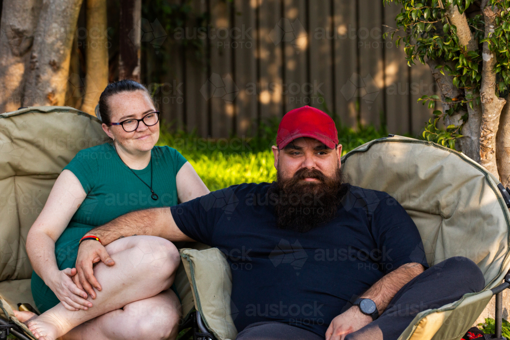 Image of First nations Australian parents relaxing together in chairs ...