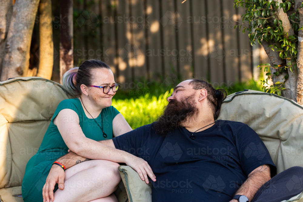 Image of First nations Australian parents relaxing together in chairs ...
