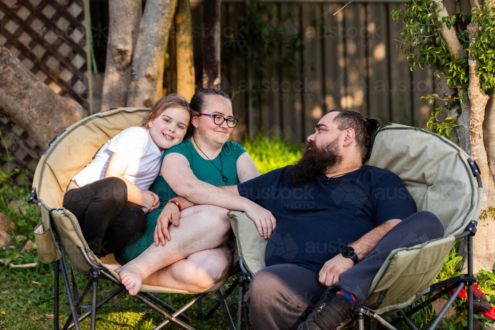 Image of First nations Australian parents relaxing together in chairs ...