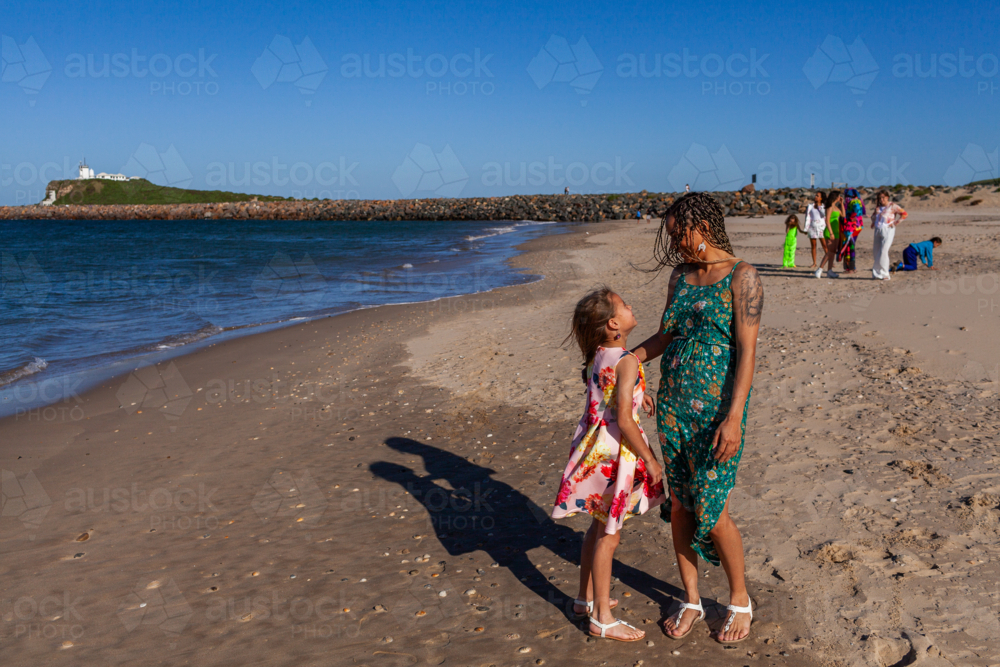 Image of First Nations Australian people together on beach on sunlit ...