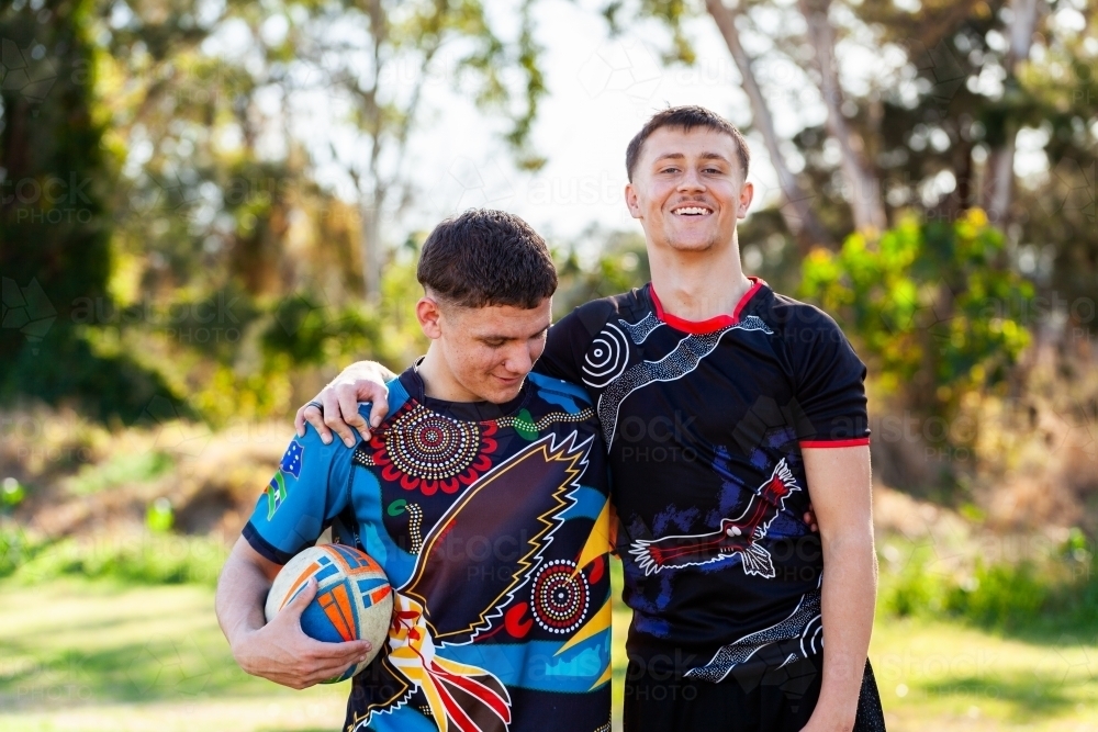 Image of First Nations Australian teammates together on edge of sports ...