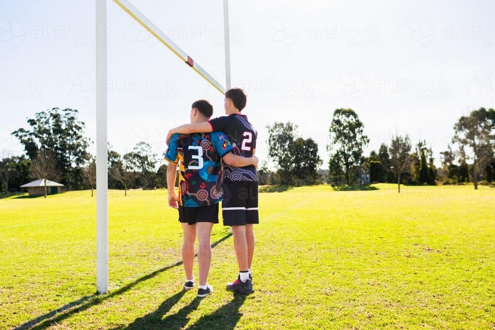 Image of First Nations Australian teammates walking towards goal post ...