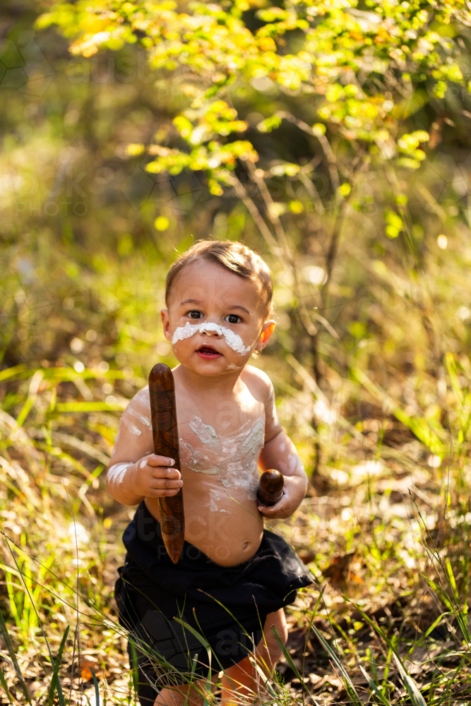 Image of First Nations Australian toddler boy painted in ochre in green ...