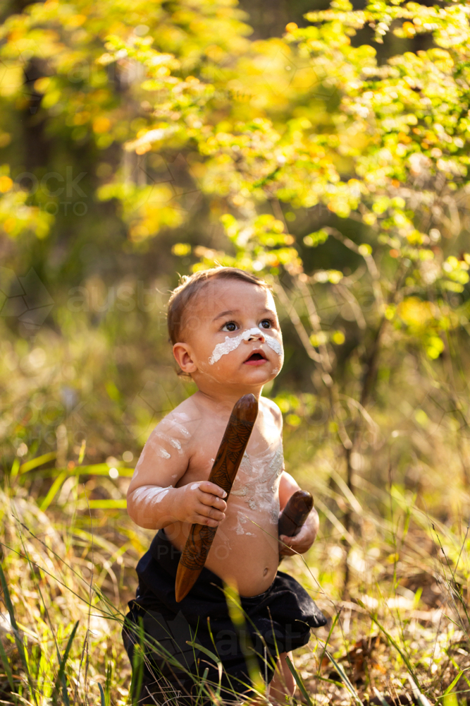 Image of First Nations Australian toddler boy painted in ochre in green ...