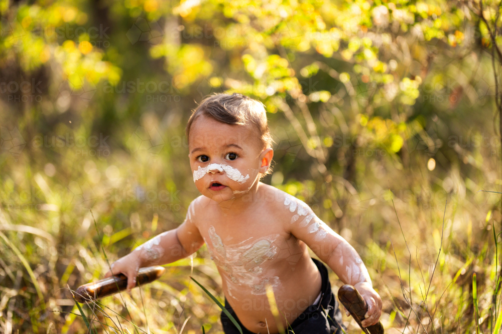 Image of First Nations Australian toddler boy painted in ochre in green ...