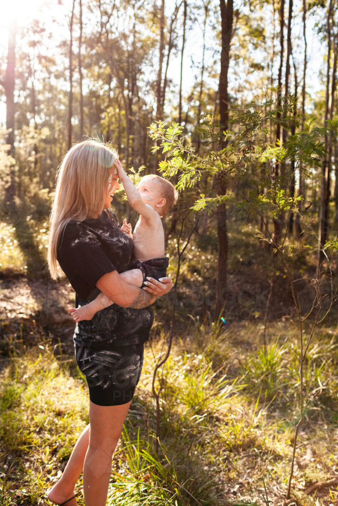 Image of First Nations Australian woman carrying child together in ...