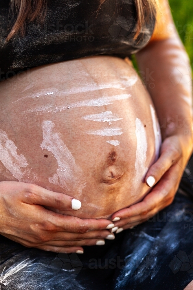 Image of First Nations Australian woman wearing ochre paint on belly ...