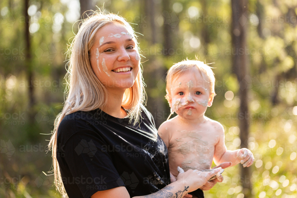 Image of First Nations Australian woman with baby boy applying cultural ...