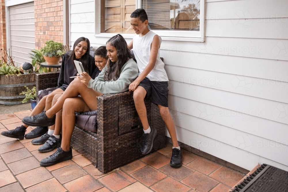 Image of First nations family sitting together on couch outside ...
