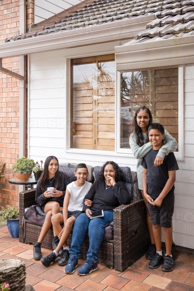 Image of First nations family sitting together on couch outside ...