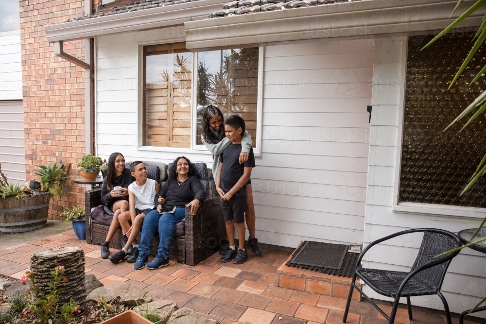 Image of First nations family sitting together on couch outside ...