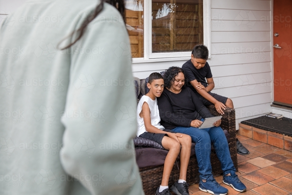 Image of First nations family sitting together on couch outside ...