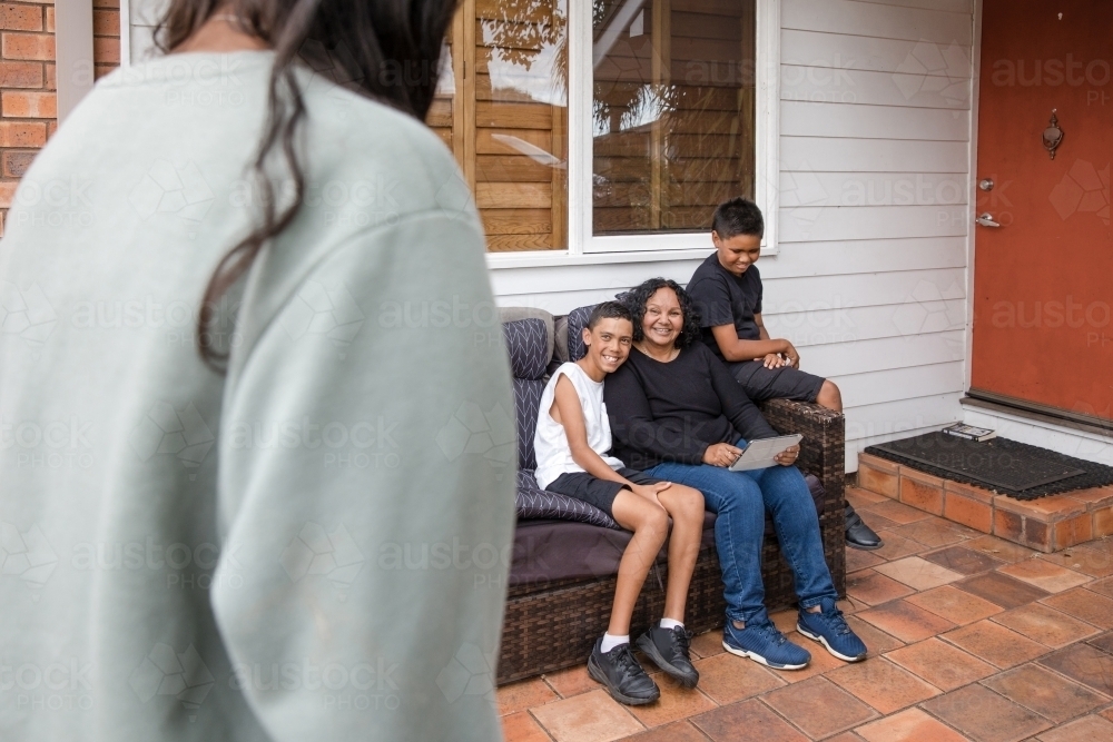 Image of First nations family sitting together on couch outside ...