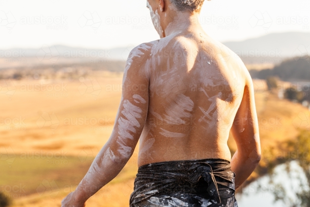Image of First Nations man storytelling while on edge of cliff on ...