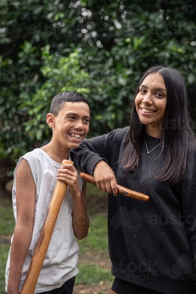 Image of First Nations teenagers holding Indigenous instruments ...