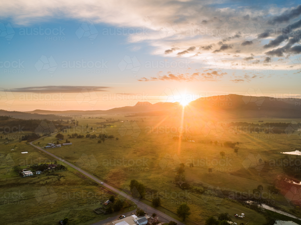 Image of first rays of sunshine at sunrise in Broke peeking from hills ...