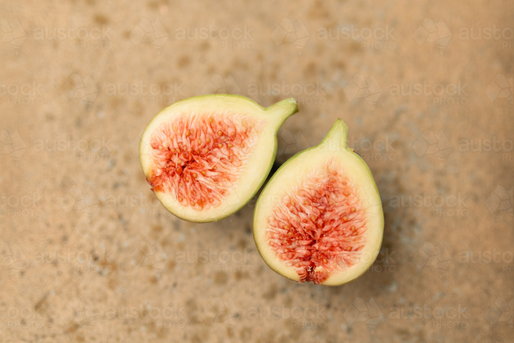 Image of Flat lay image of fig fruit cut in half on textured background ...