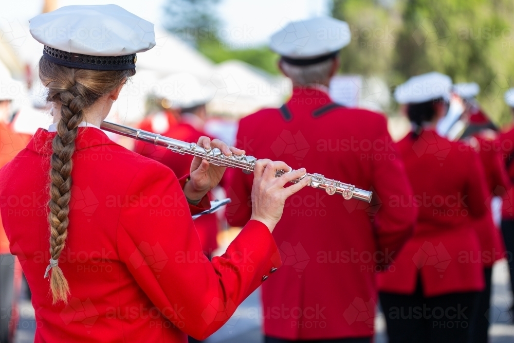 Image of Flautist playing flute in ANZAC Day parade with local band ...