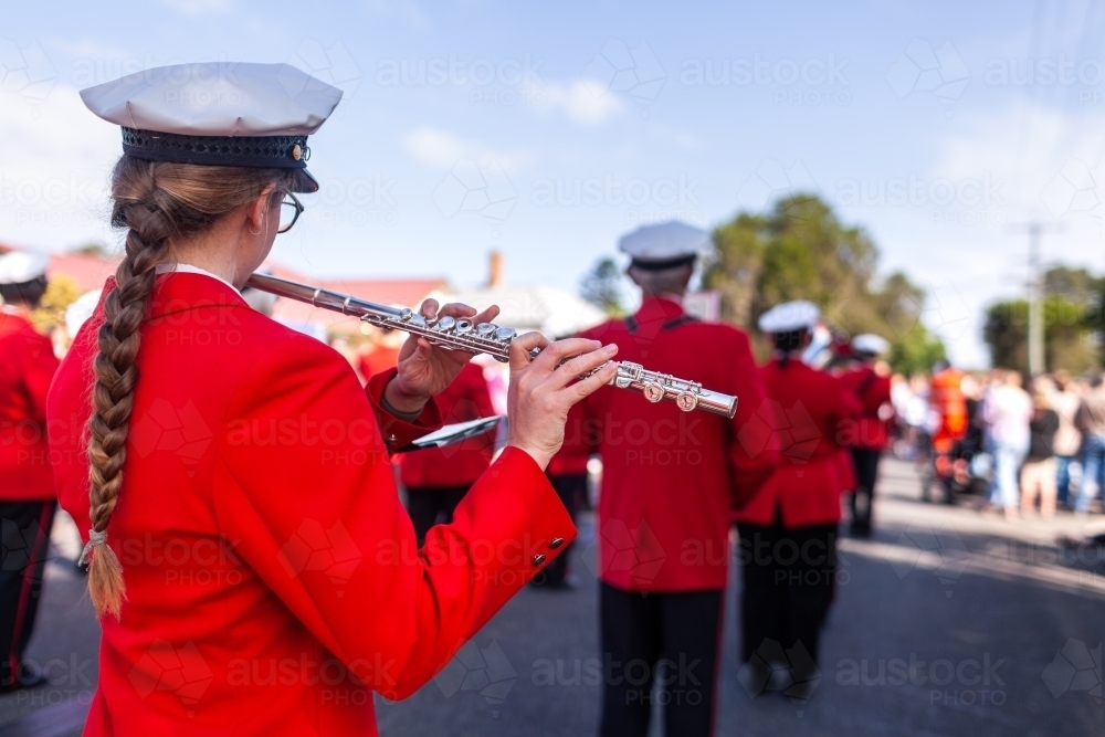 Image of Flautist playing flute in ANZAC Day parade with local band ...