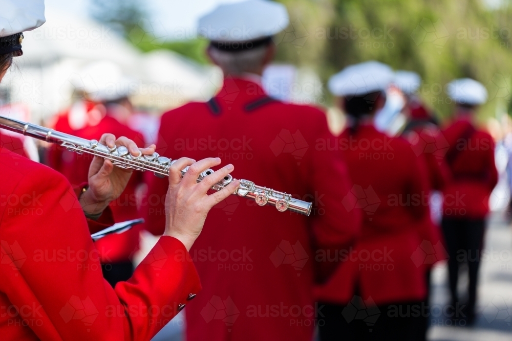 Image of Flautist playing flute in ANZAC Day parade with local band ...