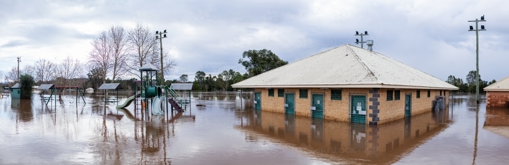 Image of flooded park and playing field with amenities building ...