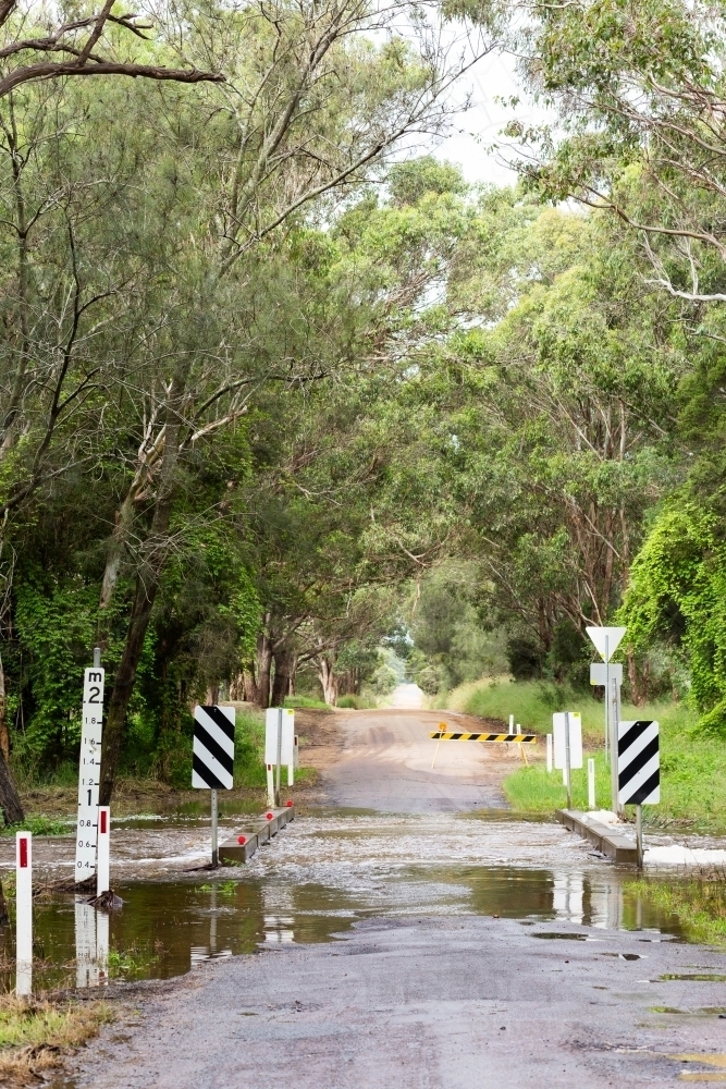 Image of Flooding causeway on country road cutting off residents ...