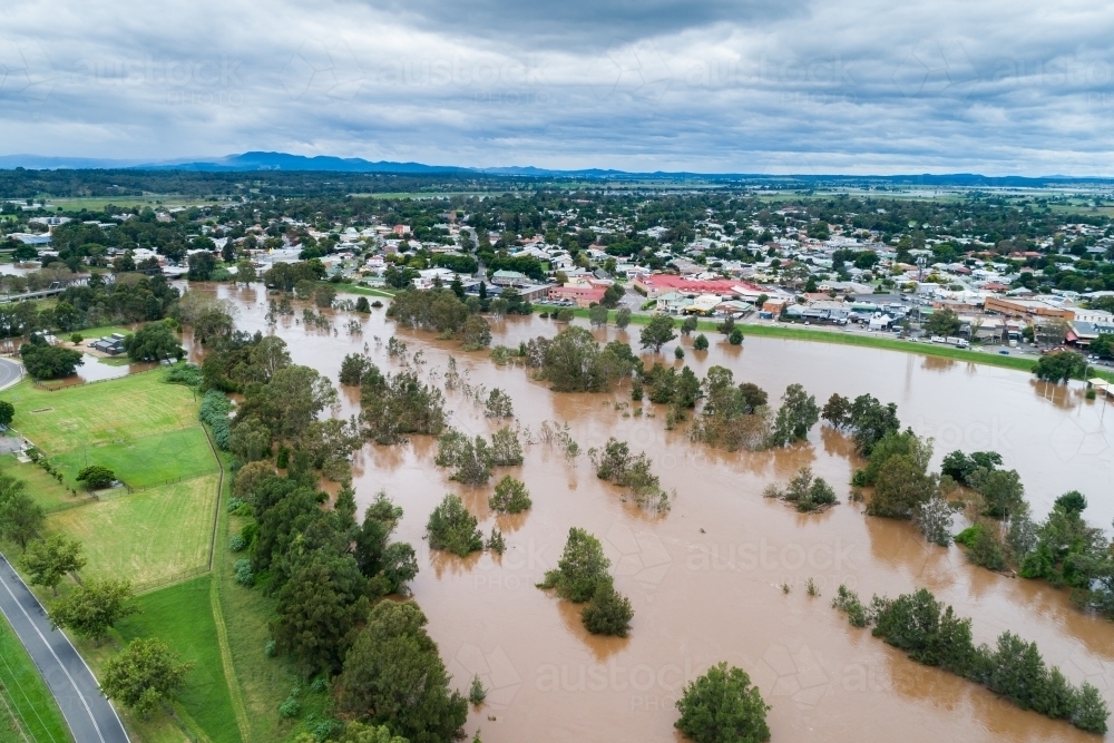 Image of Flooding river with floodwaters reaching up the levee bank ...