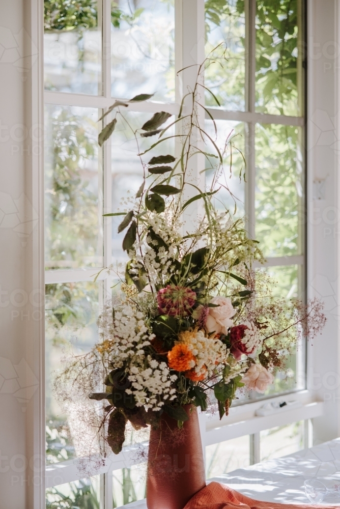 Image of Flower arrangement in window - Austockphoto