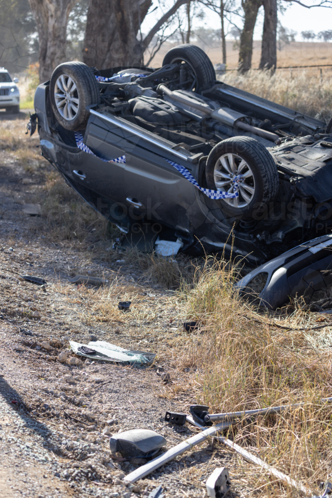 Image of focus on foreground of debris on the roadside with damaged and ...