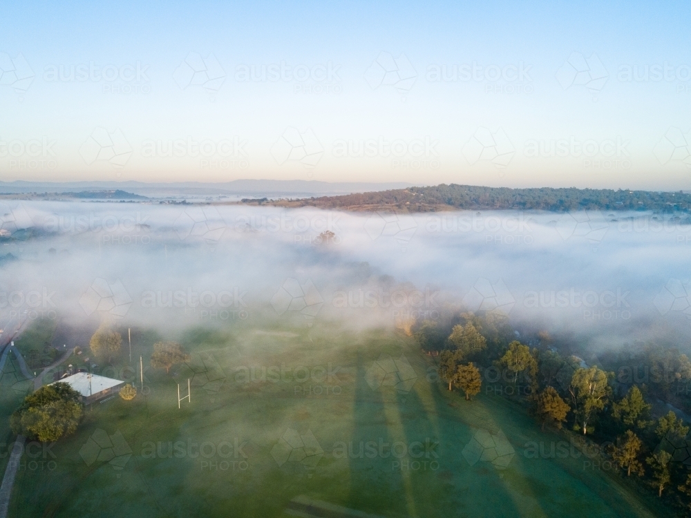 Image of fog covering recreational sports ground park area beside river ...