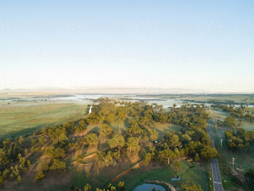 Image of Fog lying over distant farm land and paddocks in early morning ...