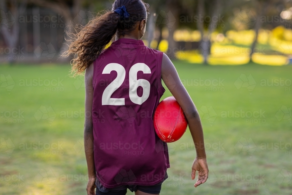 Image of football player number 26 seen from behind with red leather ...