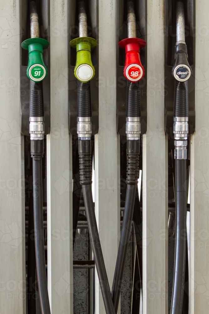 Image of Four fuel nozzles at petrol pump bowser. - Austockphoto