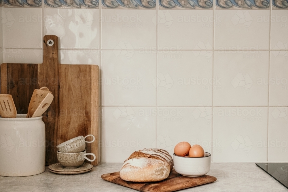 Image of Fresh bread and eggs on a kitchen bench. - Austockphoto