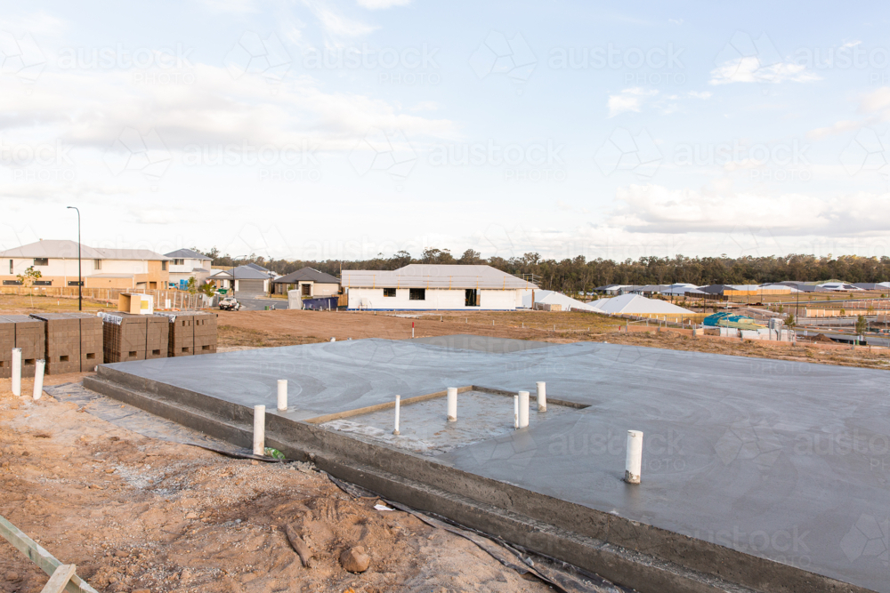 Image of fresh slab of a house under construction at a new housing ...