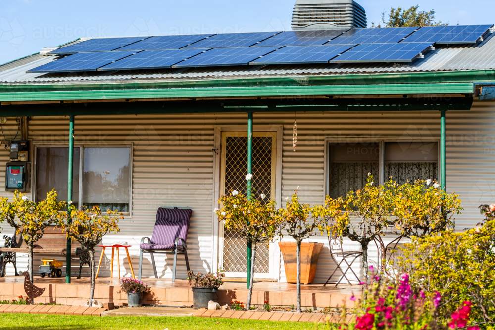 Image of Front porch and door of Aussie home with solar panels on roof ...