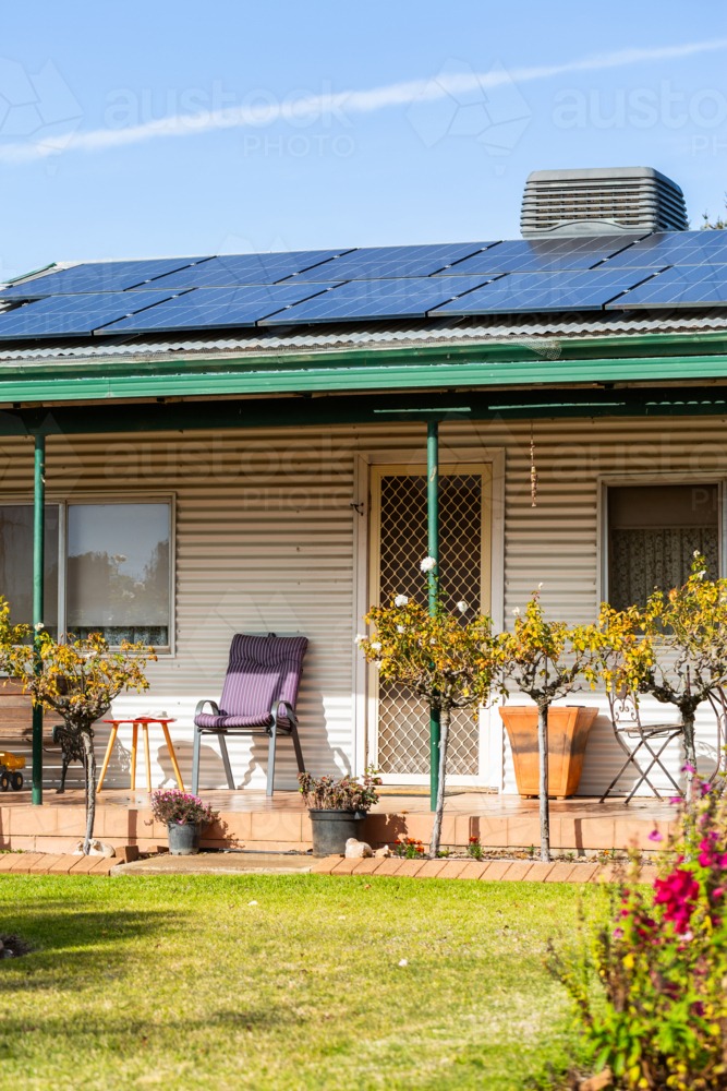 Image of Front porch and door of Aussie home with solar panels on roof ...