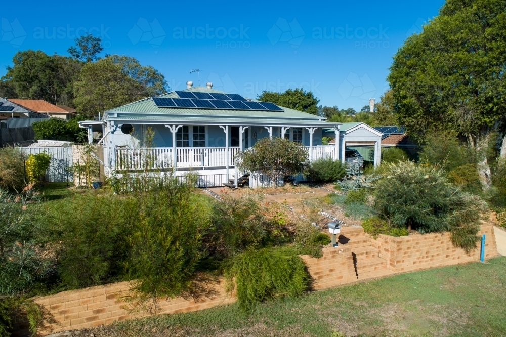 Image of Front view of Queenslander style house with solar panels ...