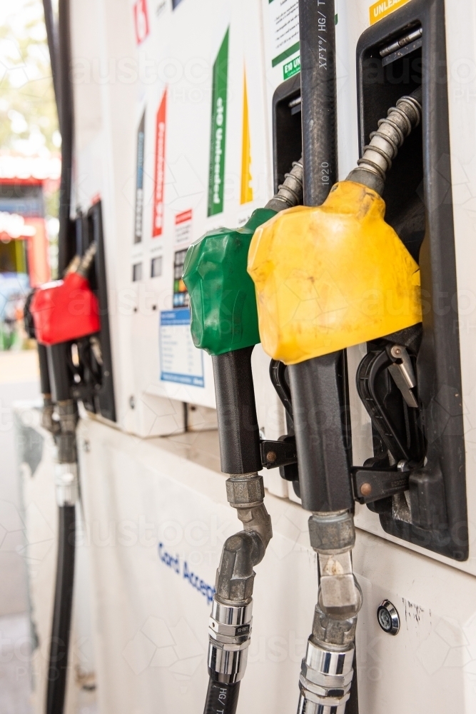 Image of fuel hoses at the bowser of a petrol station - Austockphoto