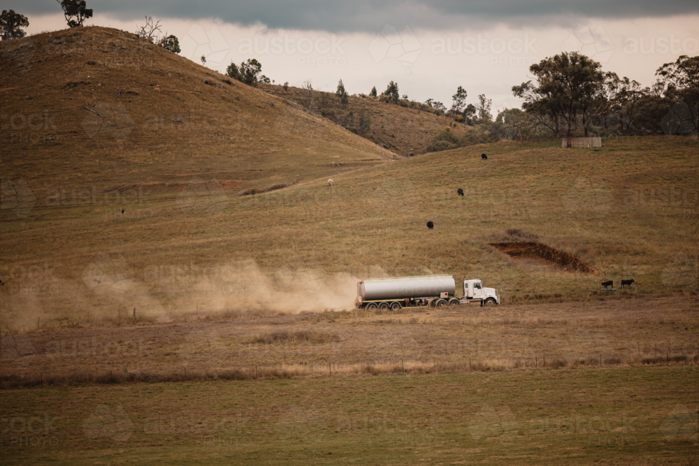 Image of Fuel tanker truck driving along rural country road - Austockphoto