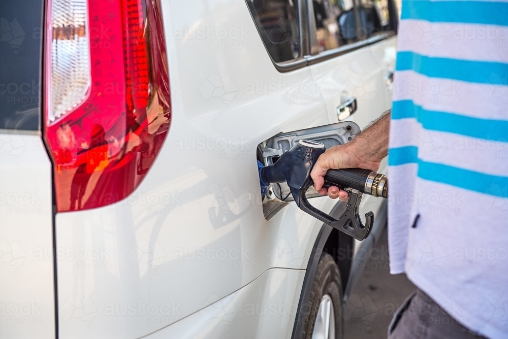 Image of Fuelling up car at petrol station - Austockphoto
